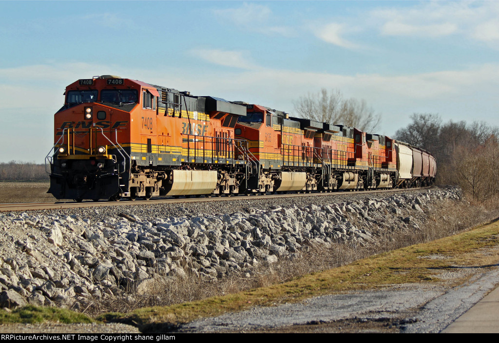 BNSF 7408 Heads into town with a grain.